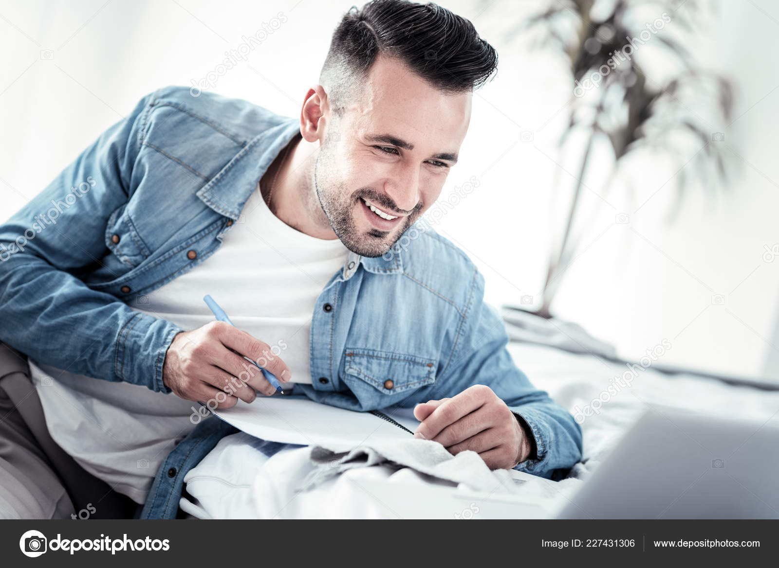 Handsome student completing his test — Stock Photo © yacobchuk1 #227431306