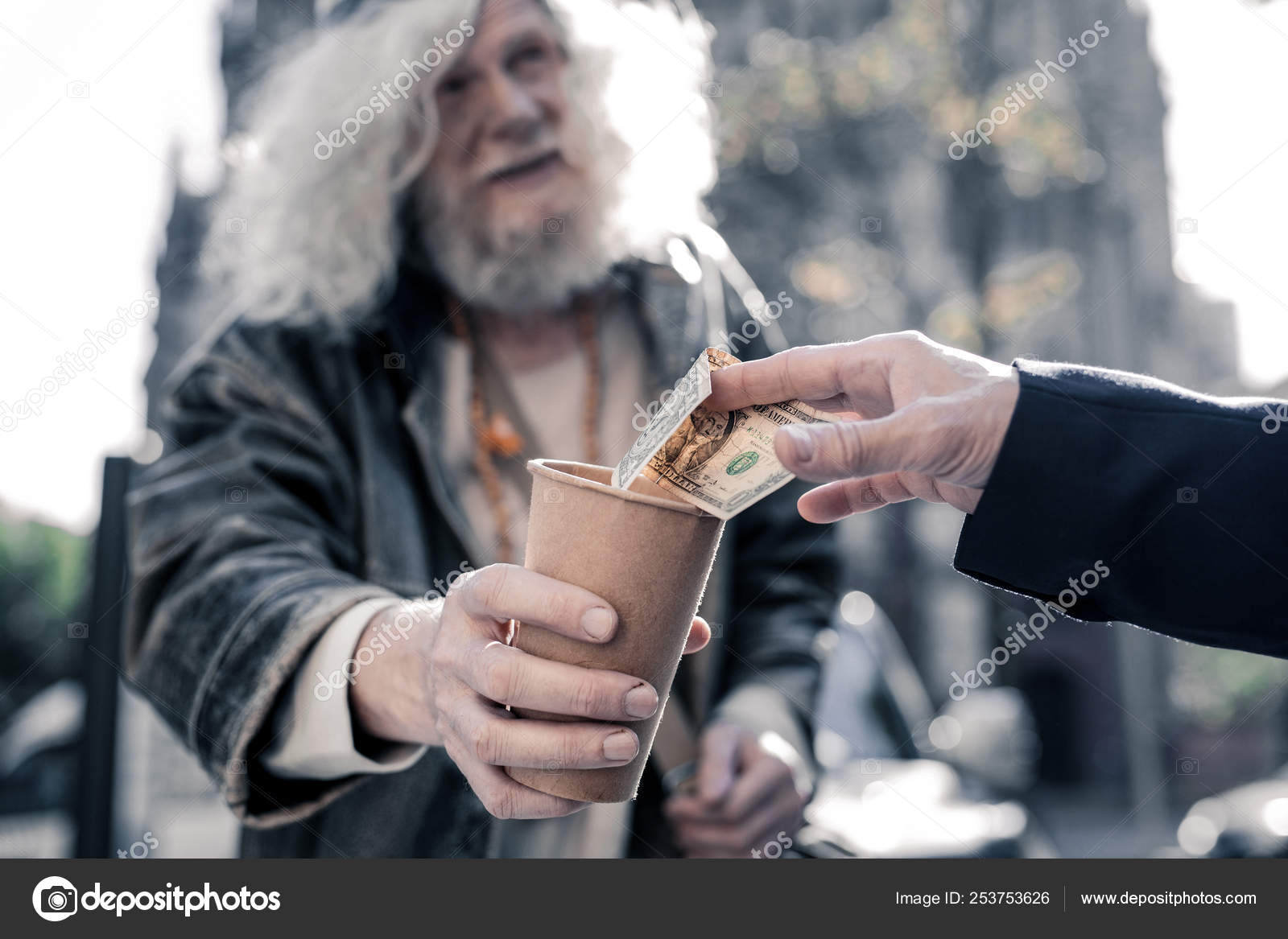 People Giving Money To The Homeless