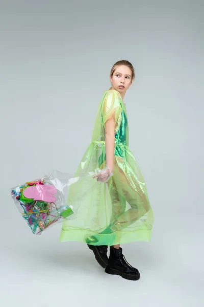 Skinny promising model posing while walking with plastic bag - Stock ...