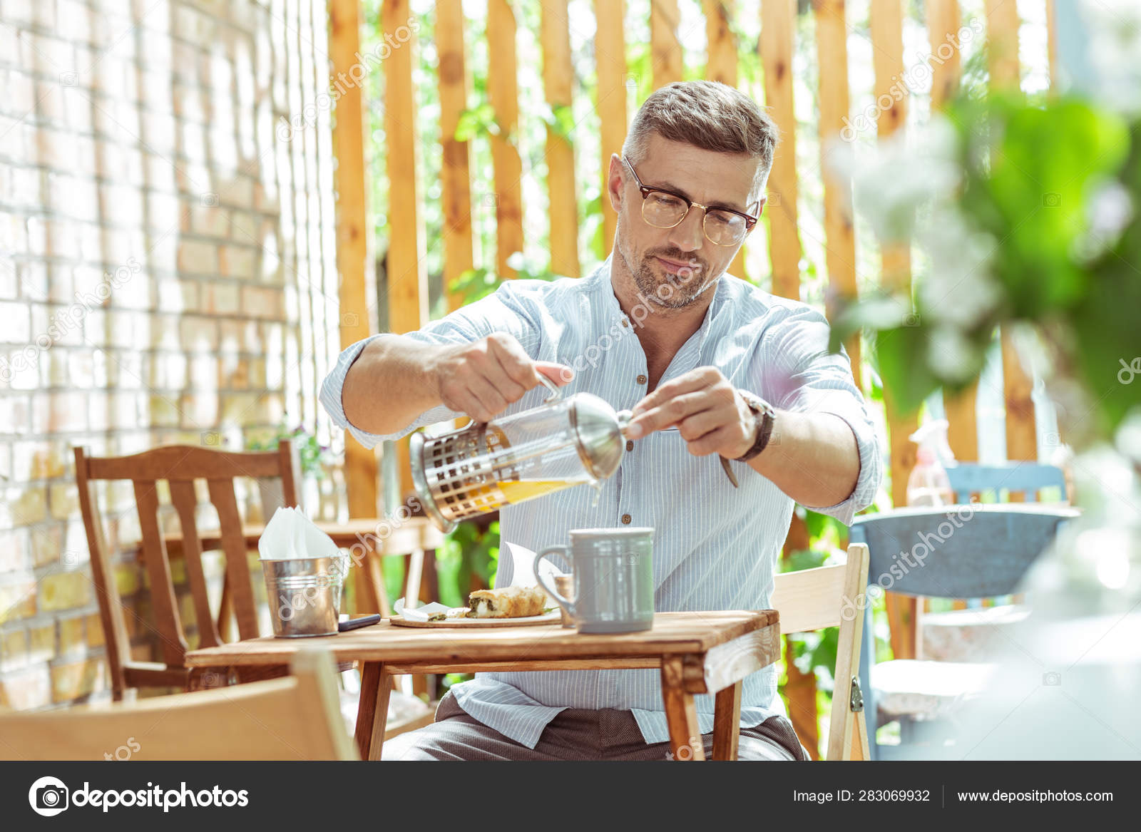 Handsome man filling his cup with tea. Stock Photo by ©yacobchuk1 283069932