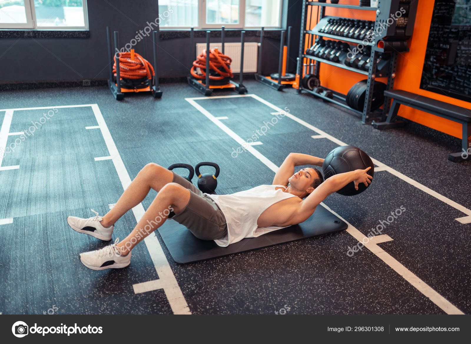 Nice good looking man lifting a black ball Stock Photo by ©yacobchuk1 ...