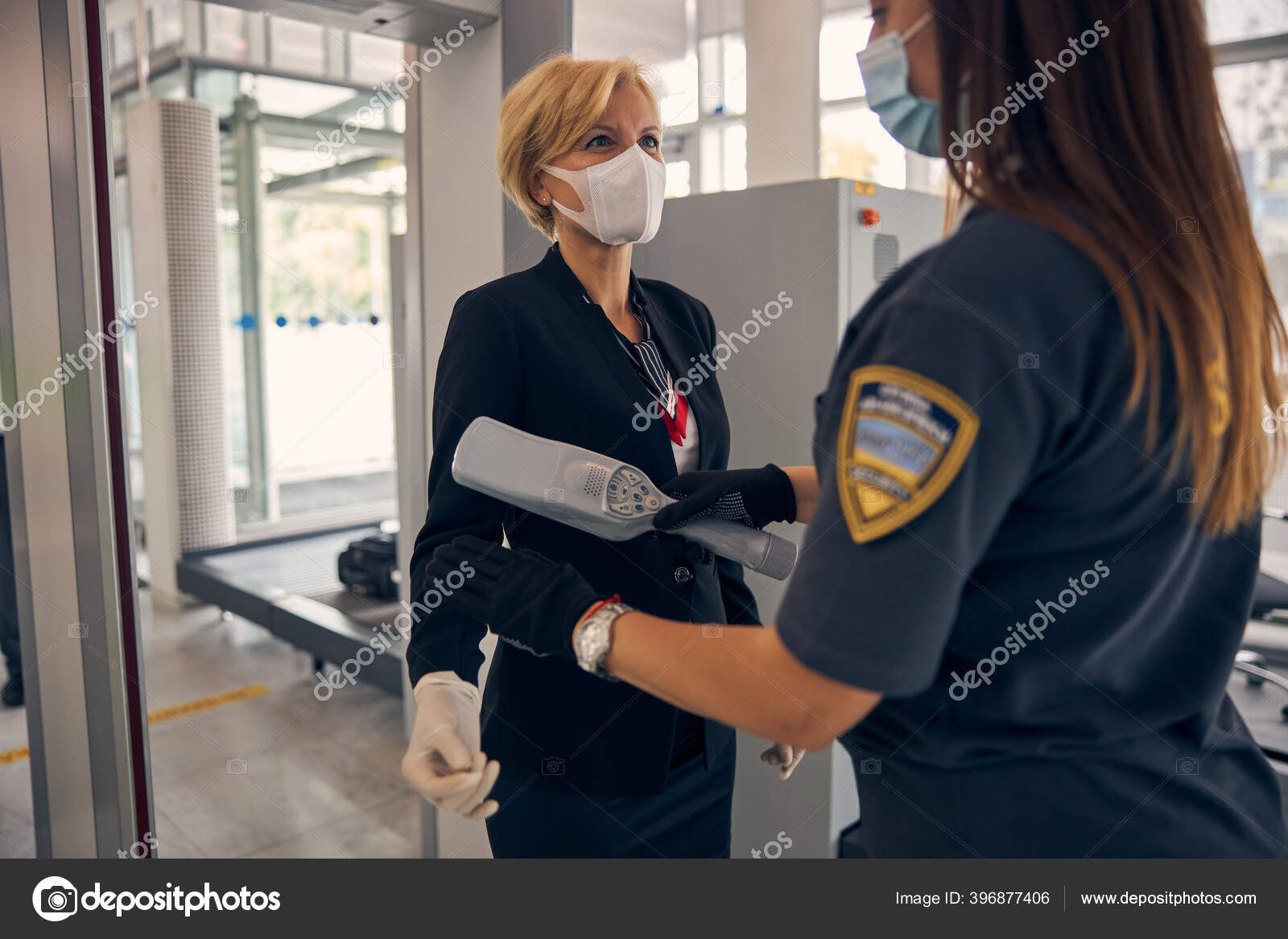 Charming businesswoman undergoing security check before the flight ...