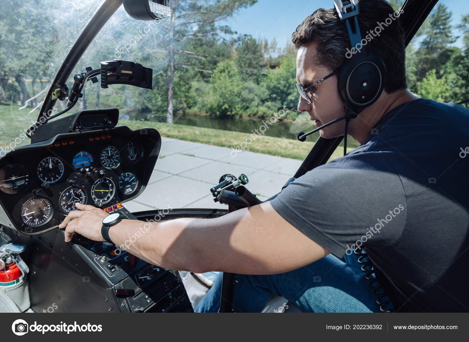 Handsome young man checking helicopter dashboard Stock Photo by ©Dmyrto ...