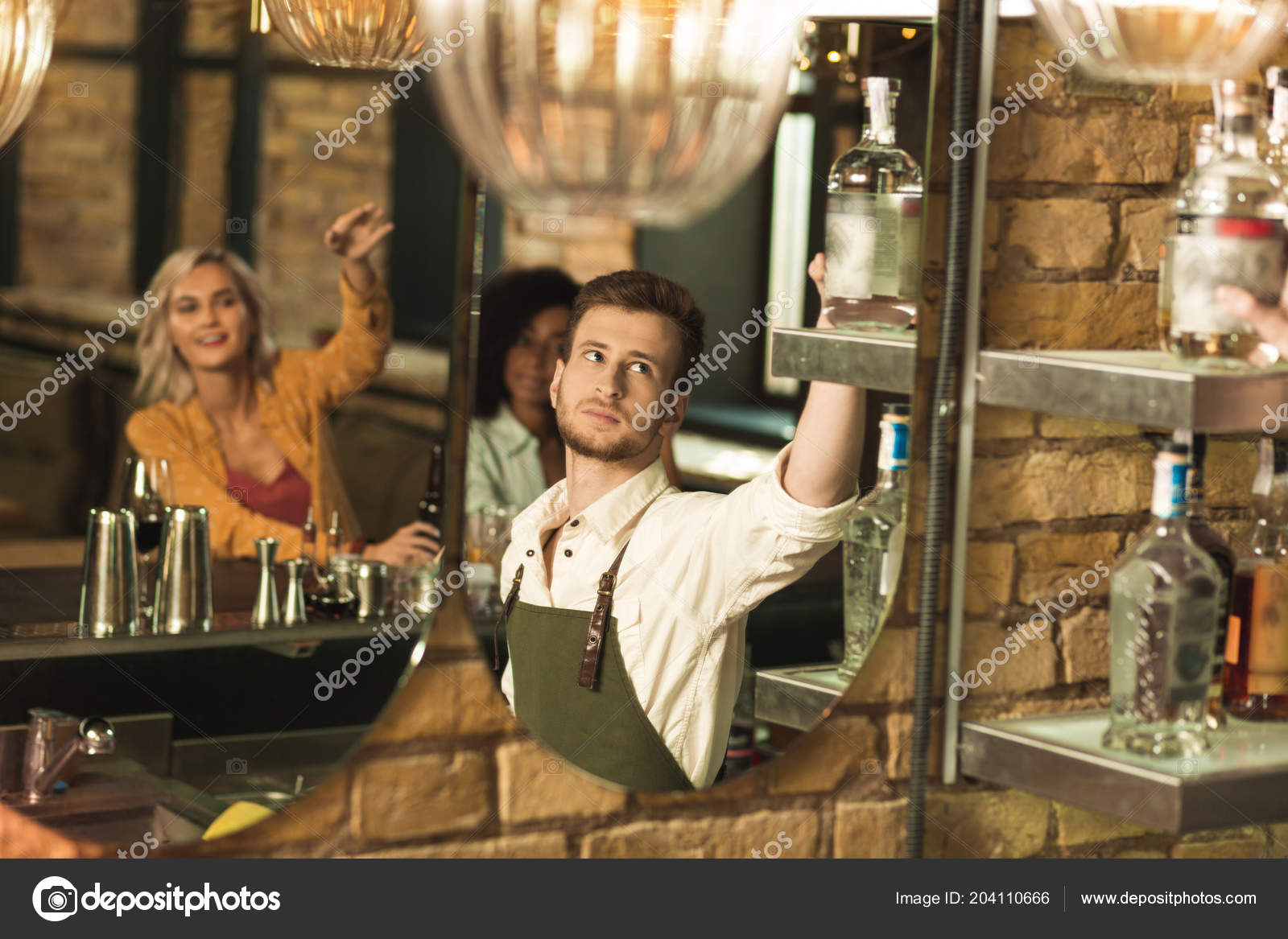 Young barman choosing alcohol to add into cocktail — Stock Photo ...