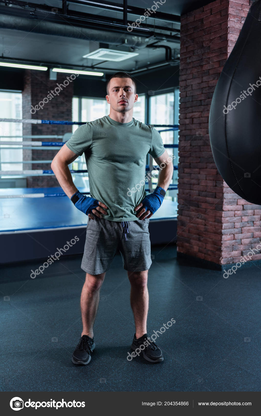 Muscle man standing in modern gym while training hard — Stock Photo ...