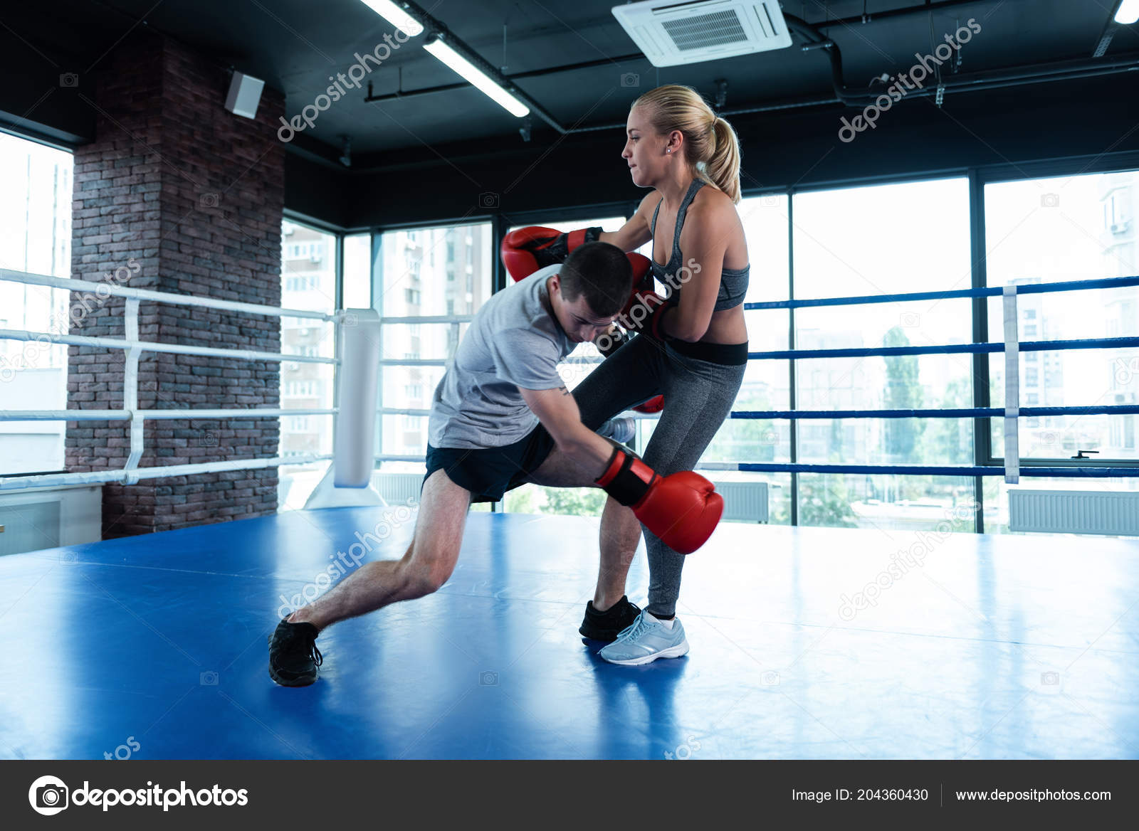 Female blonde-haired fighter being very persistent while training ...