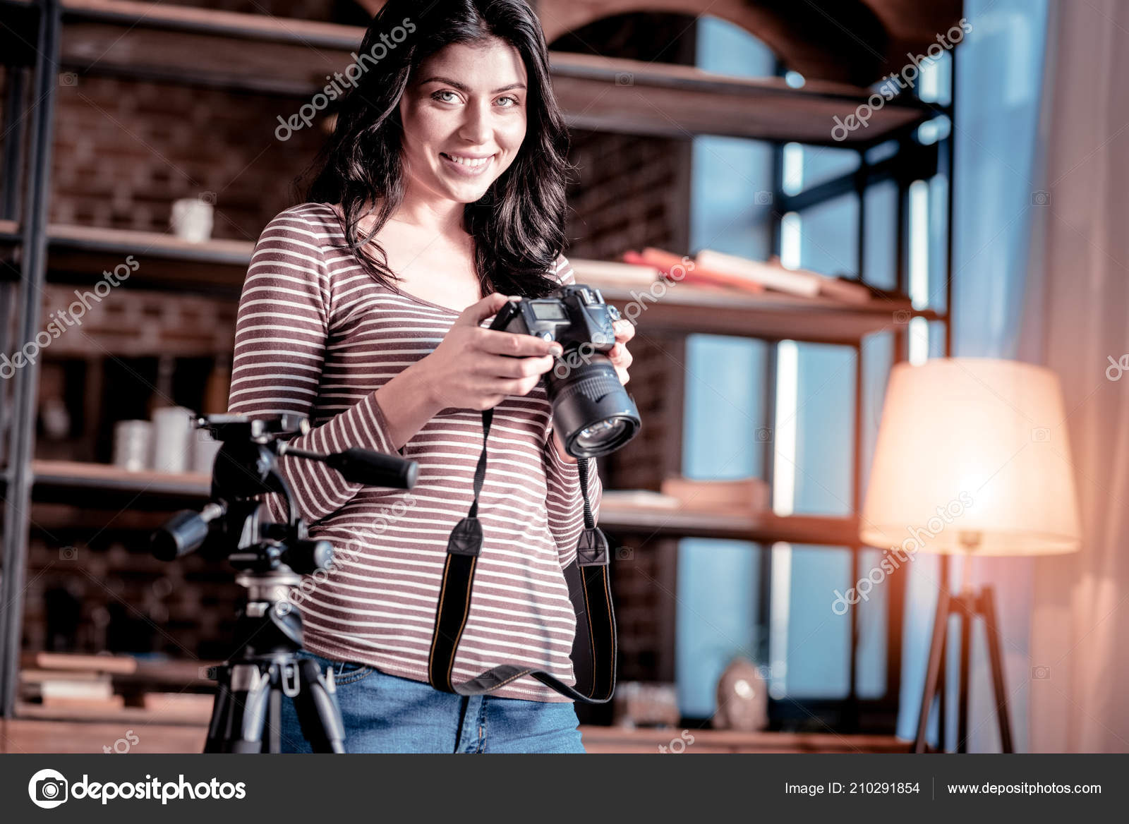 Exuberant woman looking through photos on her cam — Stock Photo ...