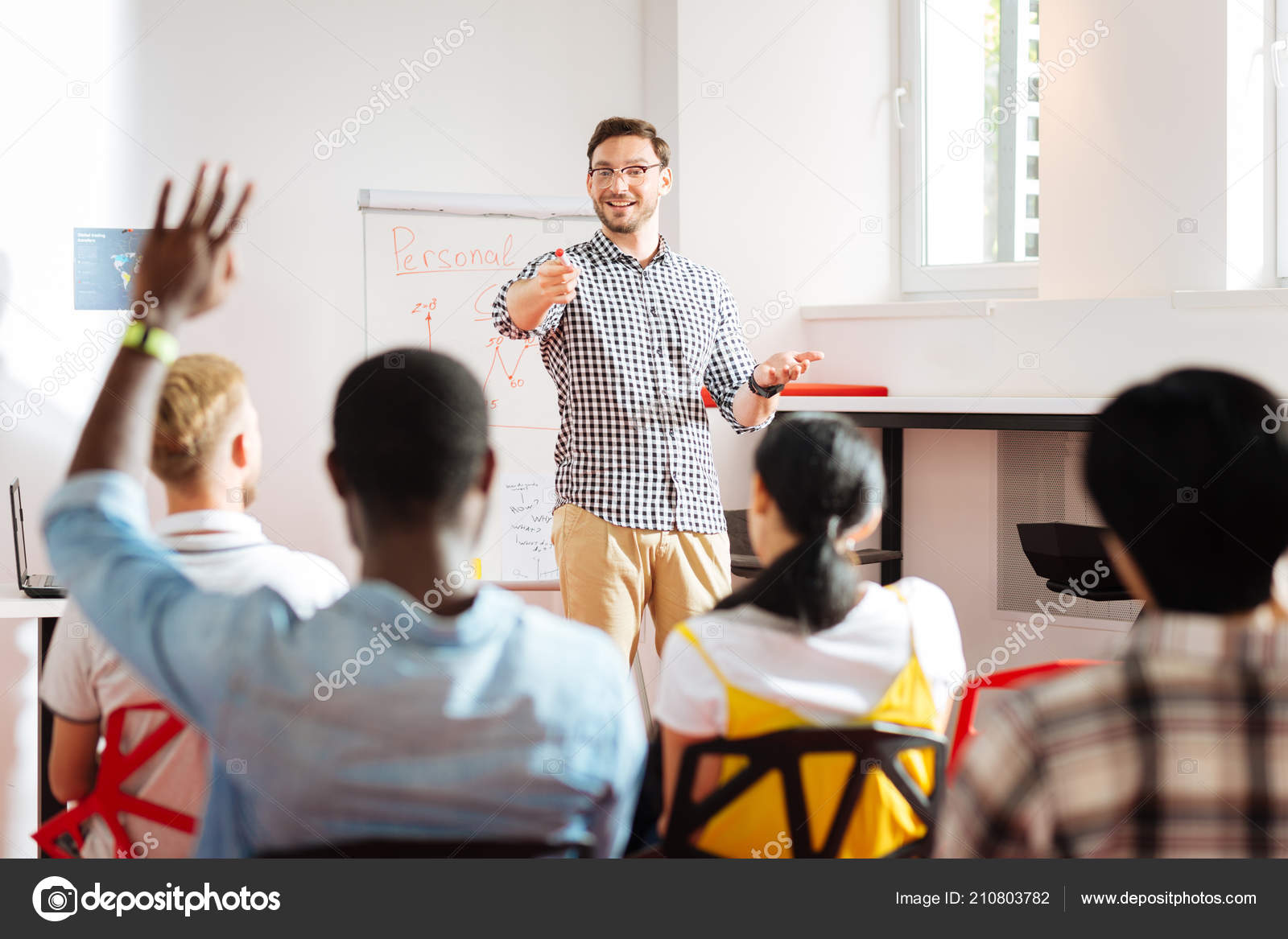 Student raising hand and cheerful speaker pointing to him — Stock Photo ...