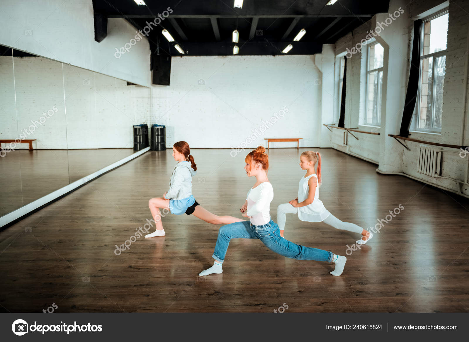 Slim beautiful ballet teacher and her students having modern dance ...