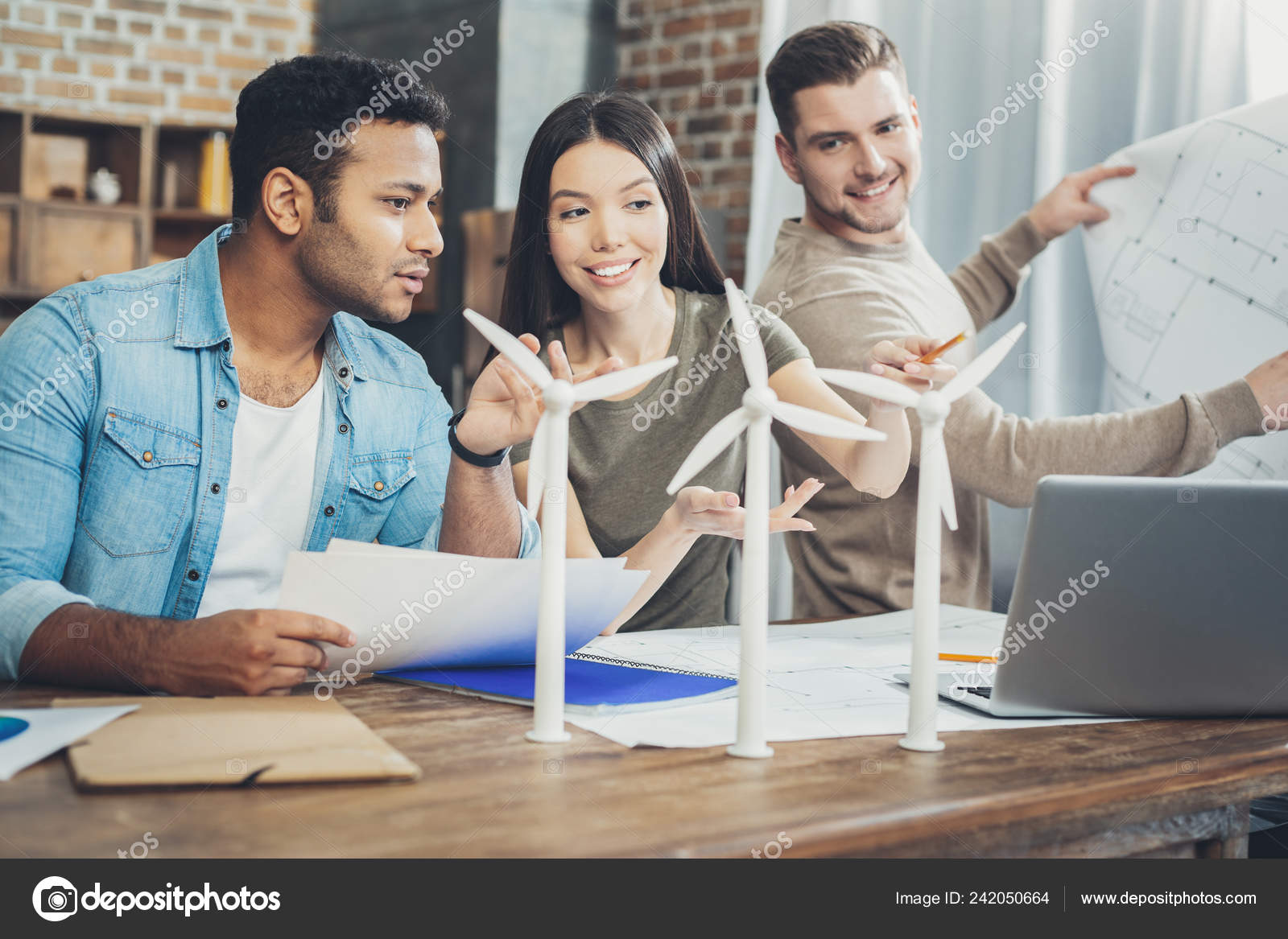 Optimistic three colleagues implementing wind power — Stock Photo ...