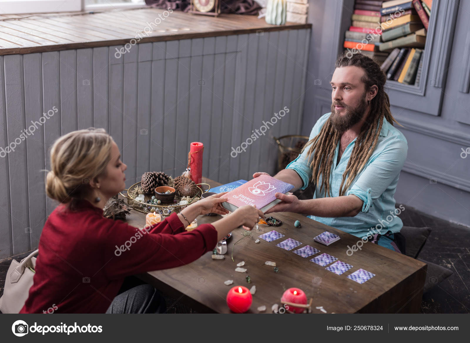 Nice serious man giving a book to his client — Stock Photo © Dmyrto_Z ...