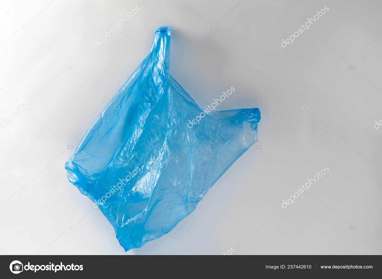 Used empty blue shopping bag being wrinkled and thrown in nature Stock ...