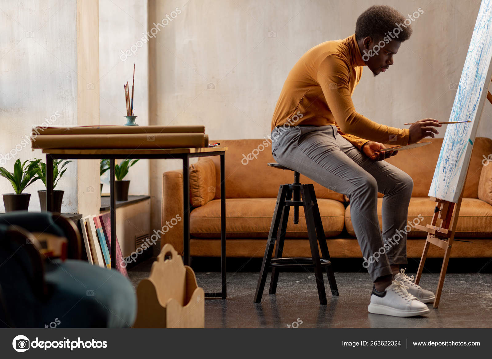 Nice hard working artist concentrating on his painting Stock Photo by ...