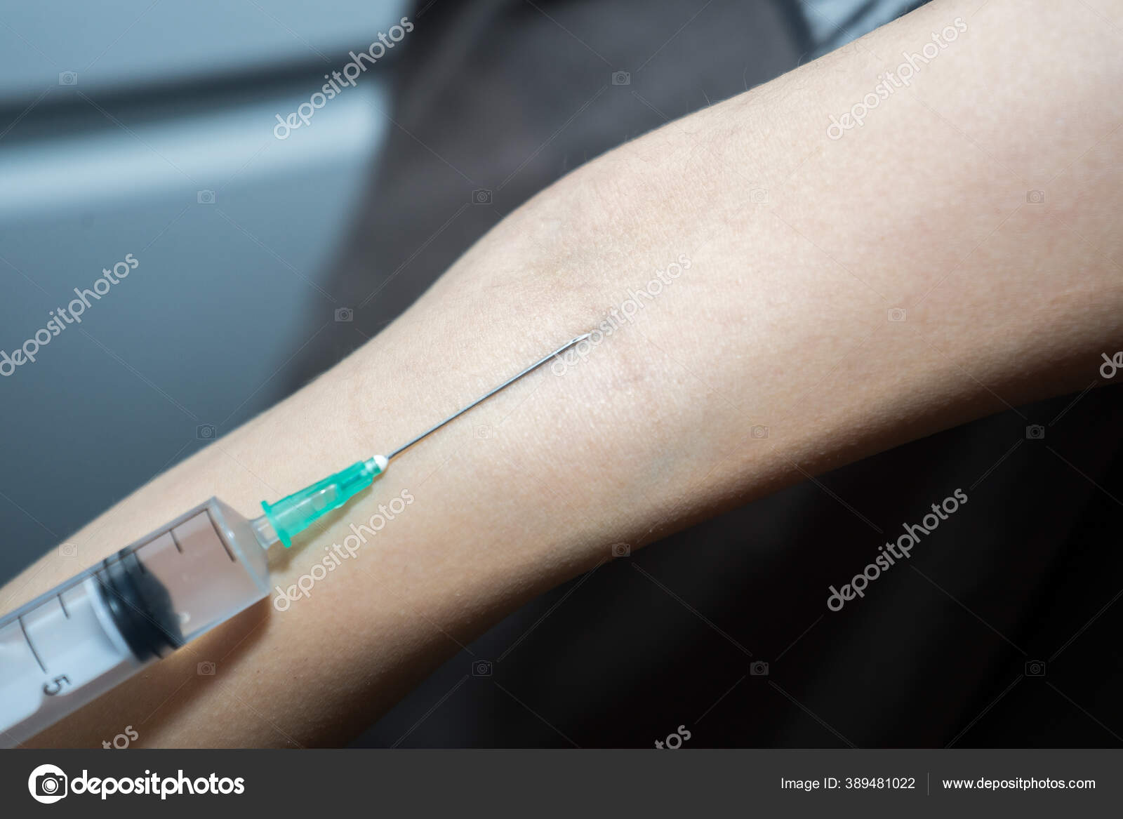 A syringe enters the patients vein. doctor makes an injection to the ...