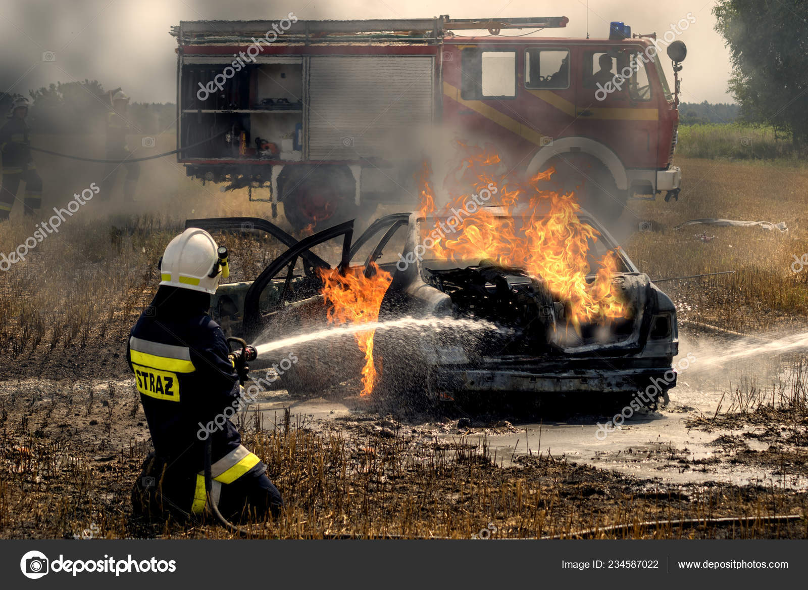 Firefighter Extinguishing Burning Car Accident Stock Photo by ...