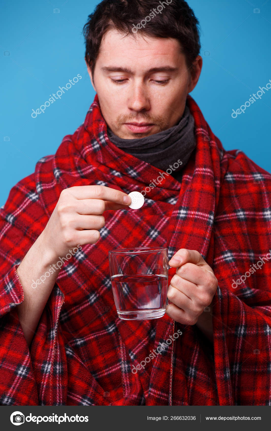 A wrapped in a blanket sick man with tablet and mug. Stock Photo by ...