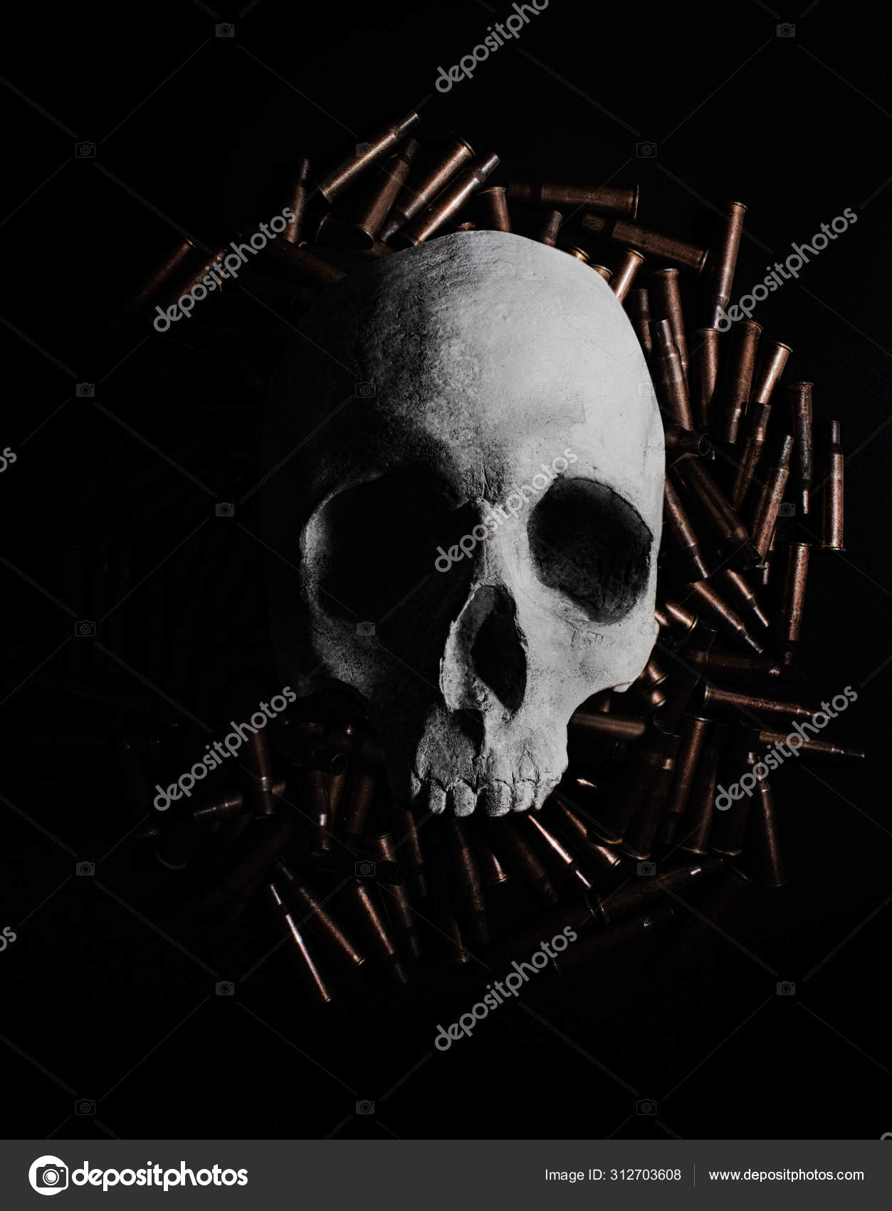 Human skull laying on a pile of gun shells. Stock Photo by ...