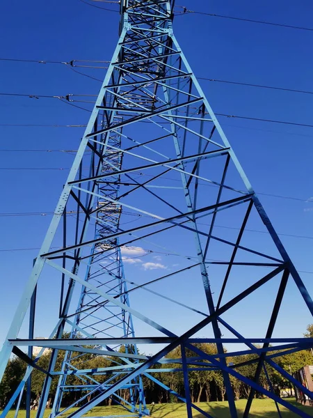 power line tower close up on a clear fine day on a blue background ...