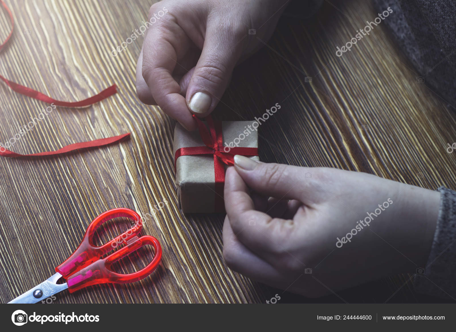 Woman Ties Red Bow Gift Box Close Photo — Stock Photo © vapm #244444600