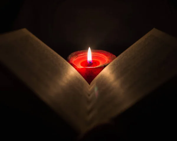 Reading a book by candlelight - Stock Image - Everypixel