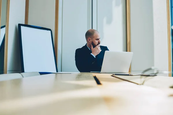 Thoughtful confident proud ceo thinking on productive strategy working ...