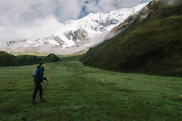 Side view of professional traveller with backpack travelling using ...