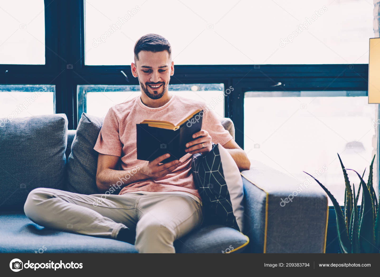 Person Reading A Book On A Couch