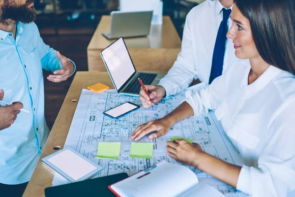 Young businessman in formal explaining information to colleagues near ...