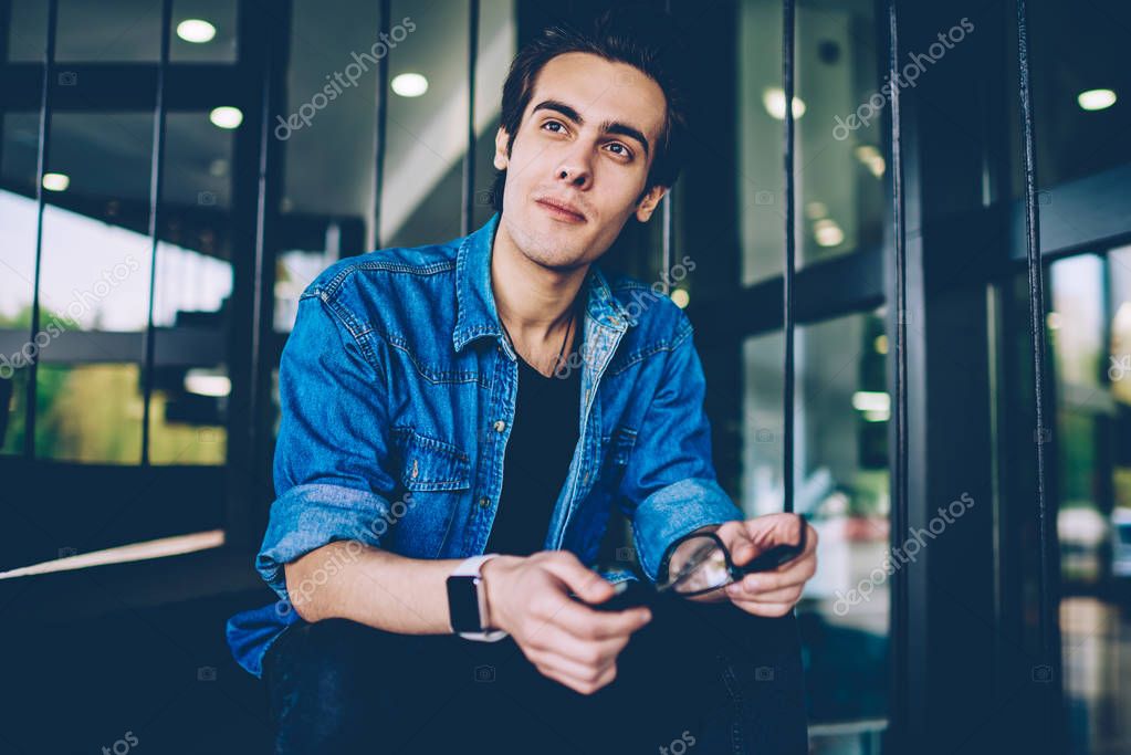 Reflexionante chico hipster vestido con traje casual con gafas ópticas ...