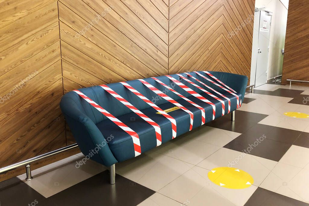 el banco en el centro comercial está cubierto con cinta de rayas para ...