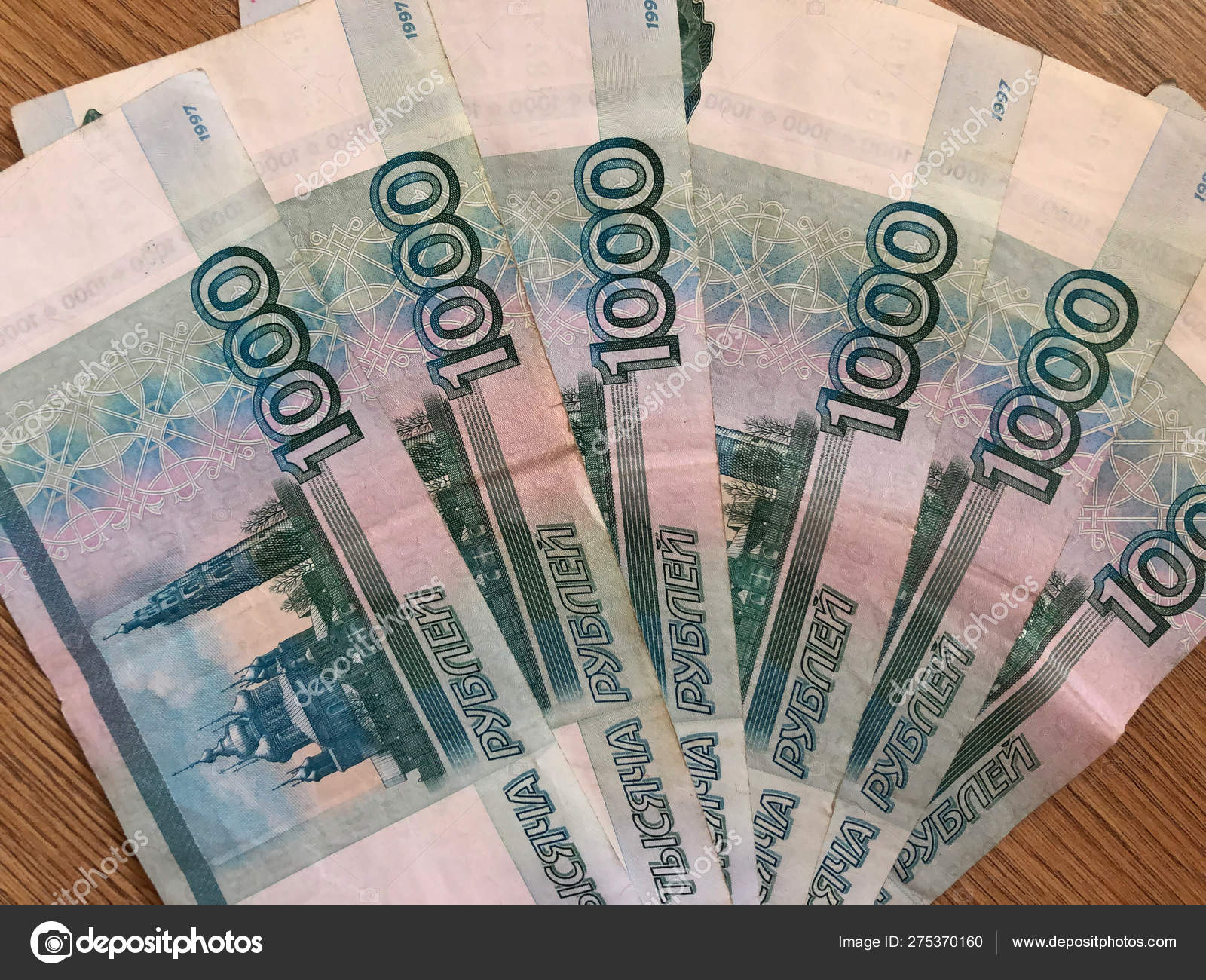 Russian banknotes in denominations of 1000 rubles on a wooden ...