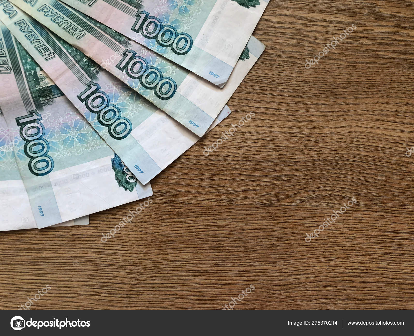 Russian banknotes in denominations of 1000 rubles on a wooden ...