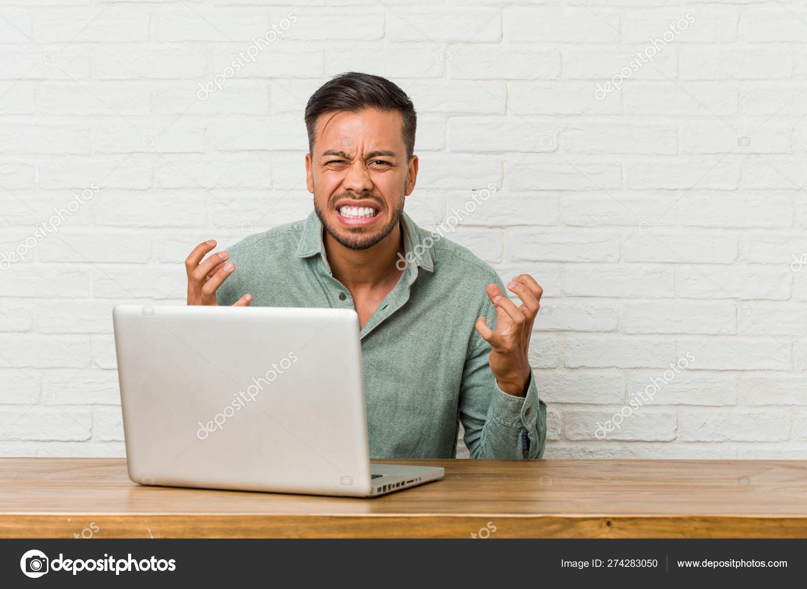 Young Filipino Man Sitting Working His Laptop Screaming Rage Stock ...