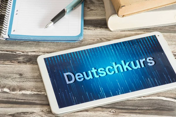 A booklet, textbooks and Tablet PC for the German course - Stock Image ...