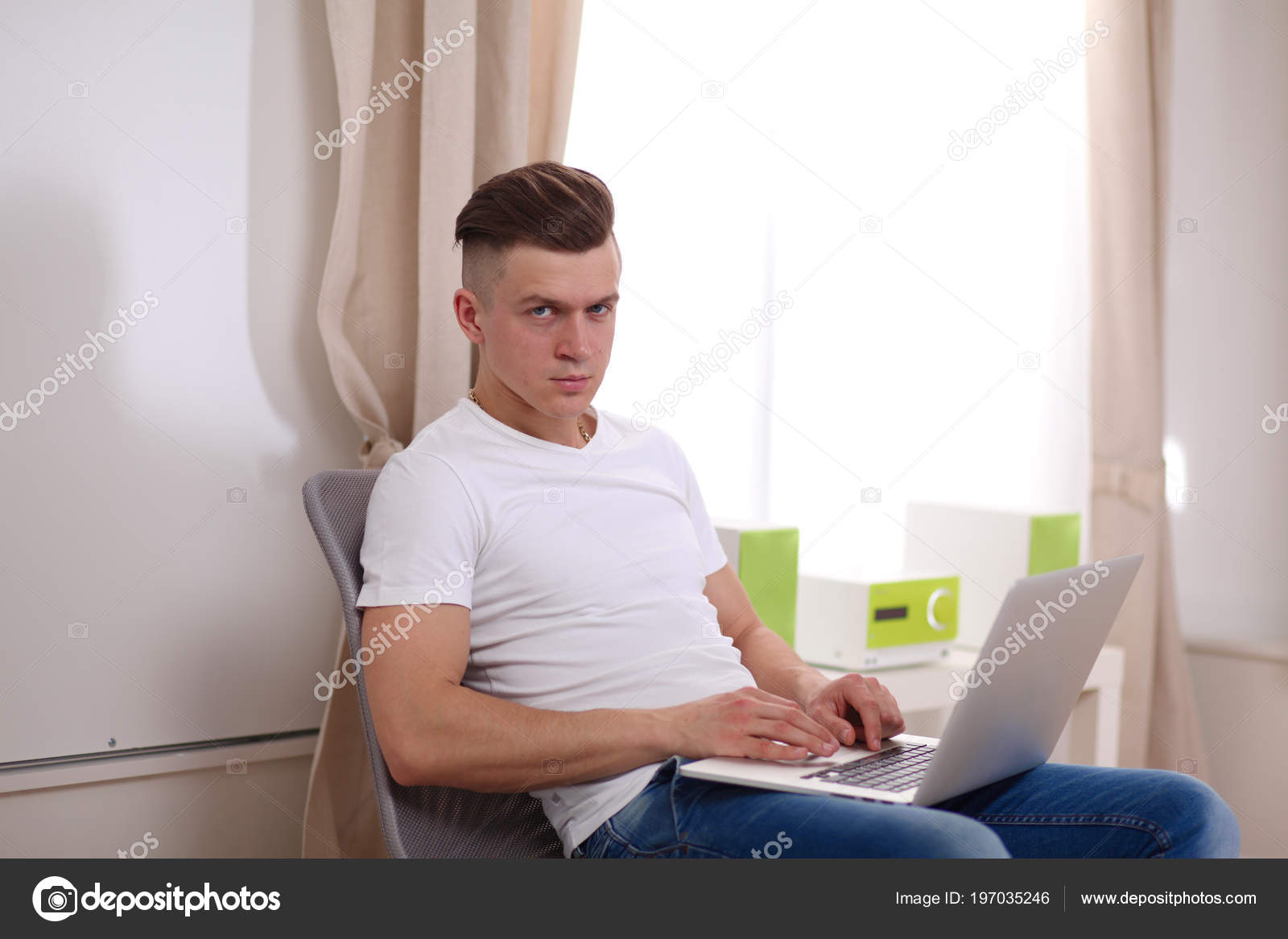 Young man sitting on chair with laptop Stock Photo by ©lenetssergey ...