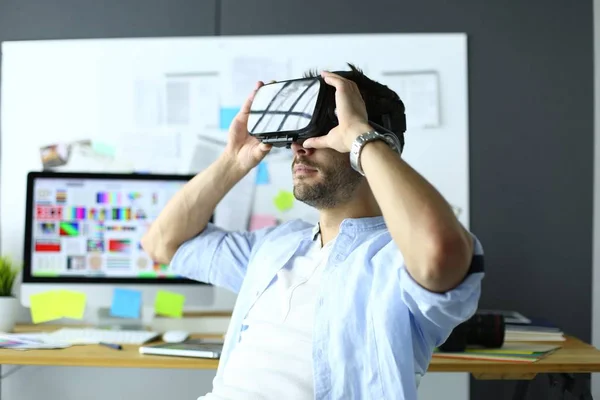 Young male software programmer testing a new app with 3d virtual ...