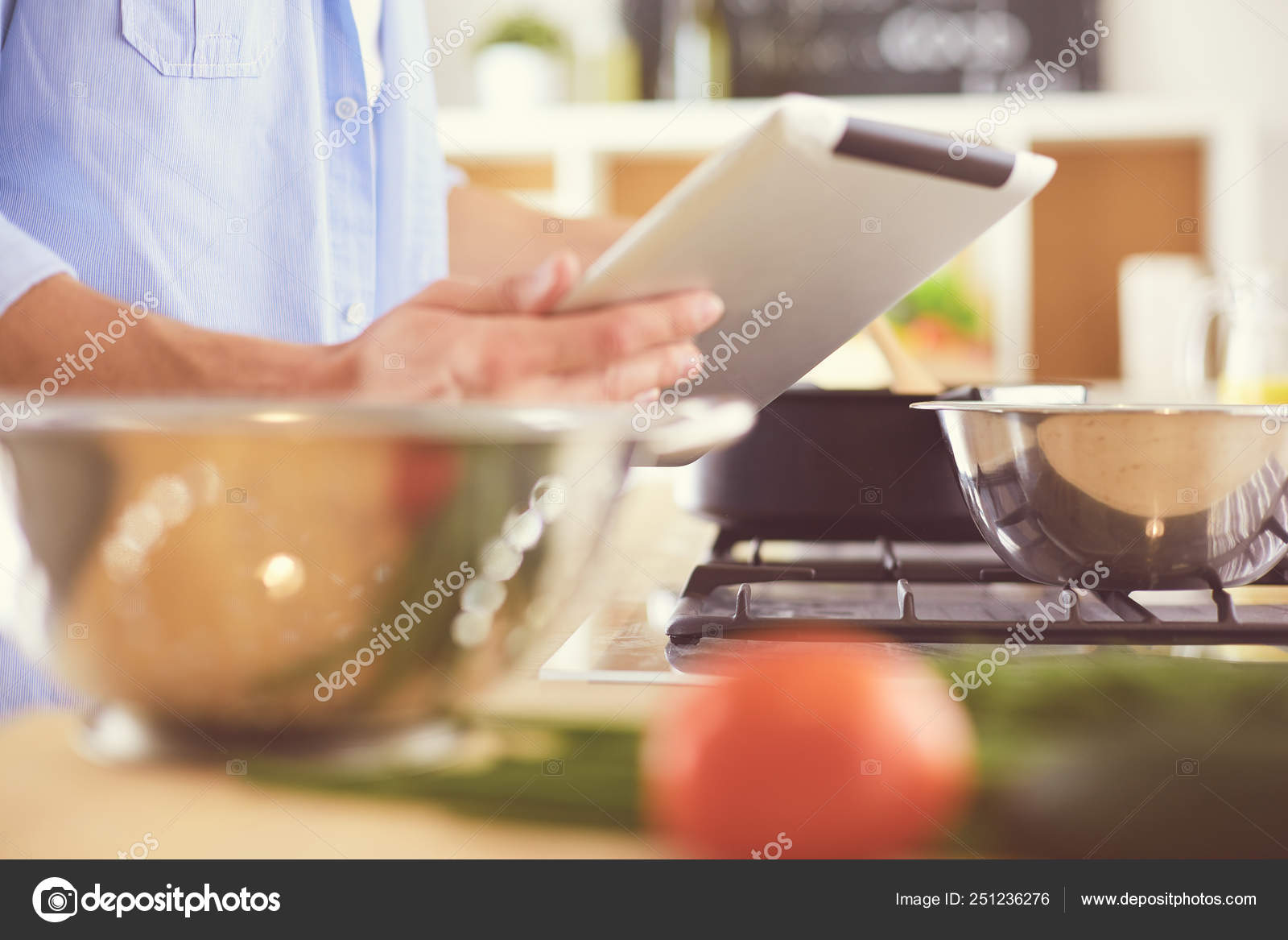Man following recipe on digital tablet and cooking tasty and healthy ...