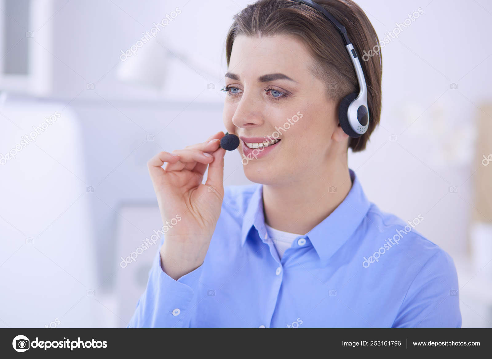 Serious pretty young woman working as support phone operator with headset in office Stock Photo ...