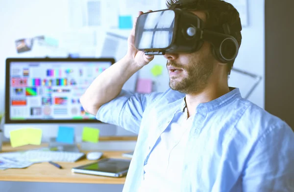 Young male software programmer testing a new app with 3d virtual ...