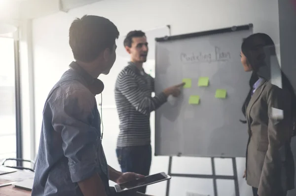 Group of young coworkers discussing ideas and presentation with each ...