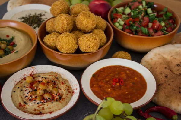 Authentic food of Middle East. Plate of hummus, falafels, pita bread ...