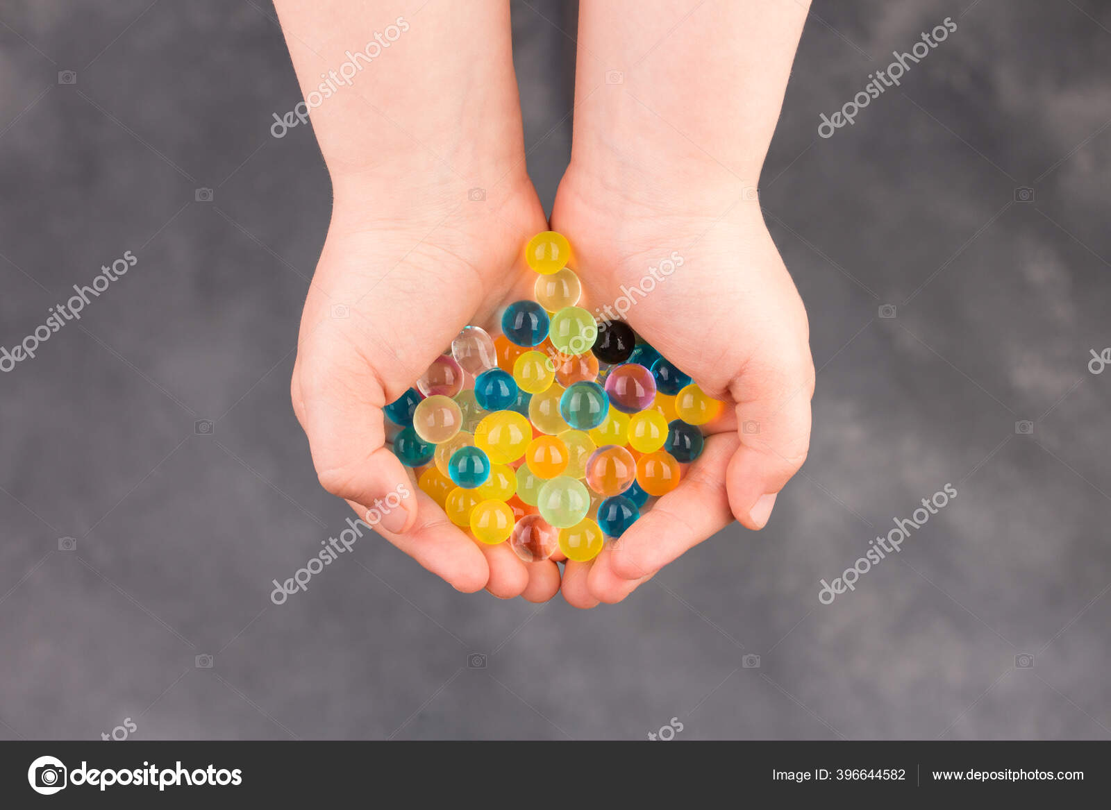 Water multiclooured gel balls. Child palms with hydrogel balls - orbeez ...