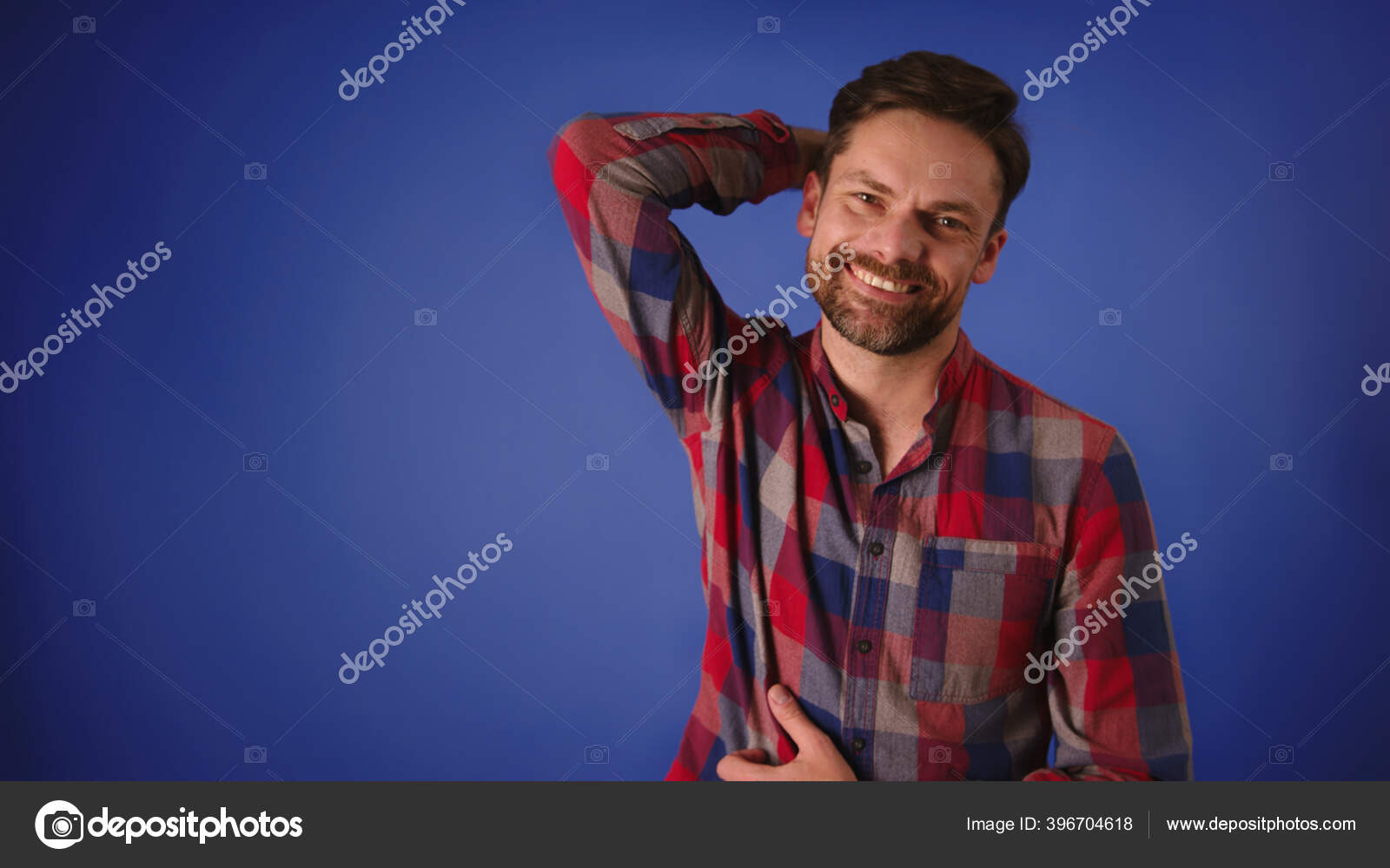 Attractive happy bearder caucasian man posing with hand on his head ...