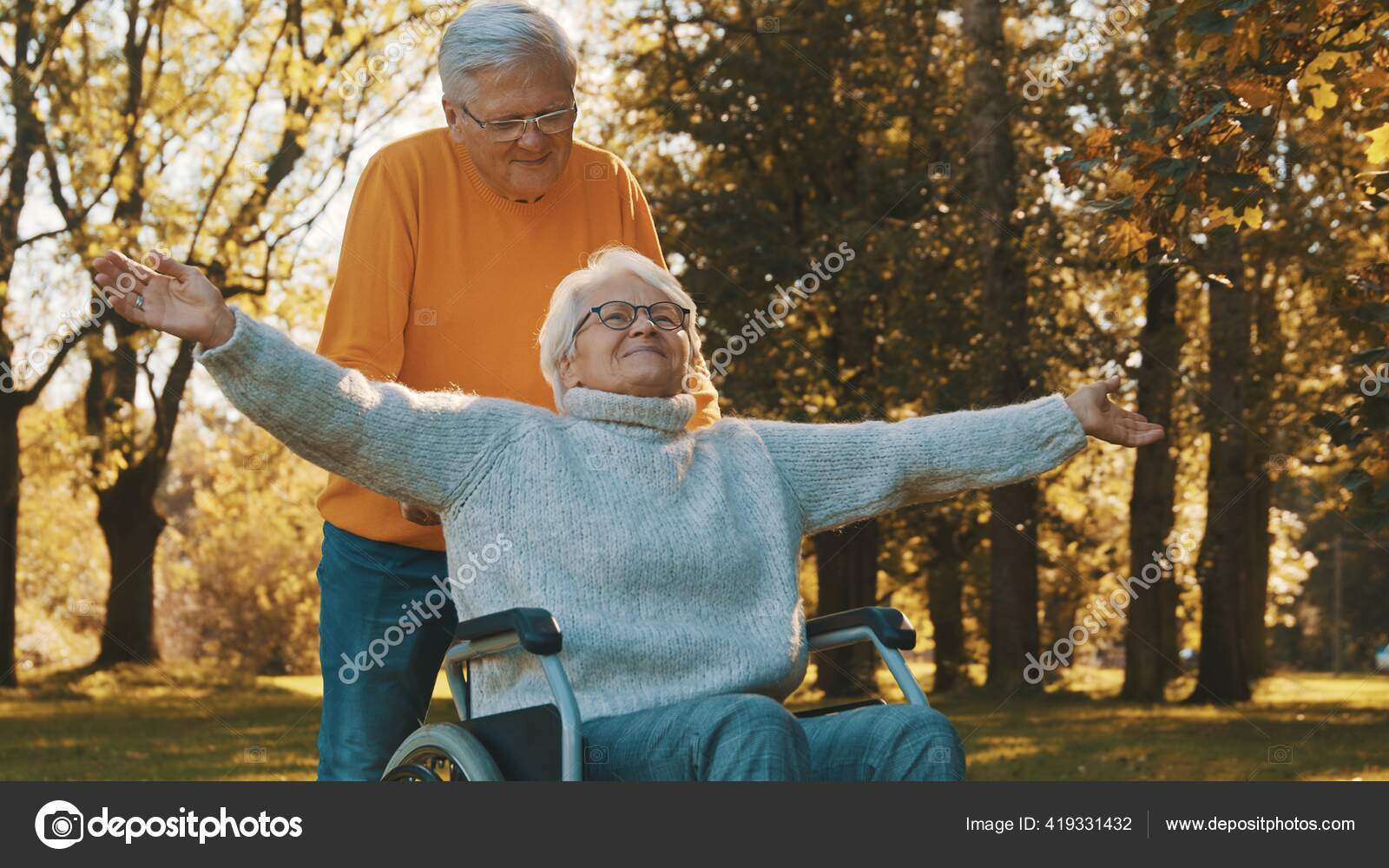 Old couple having romantic autumn day in forest. Hugging tree and ...