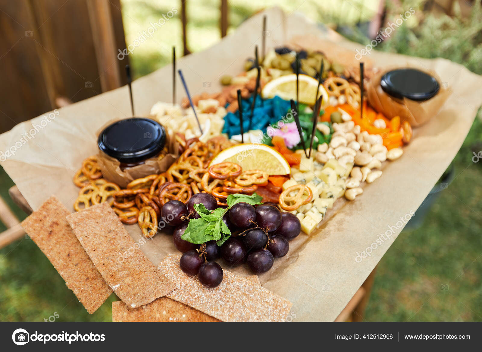 Wooden buffet table with snacks, appetizer and fruits Stock Photo by ...