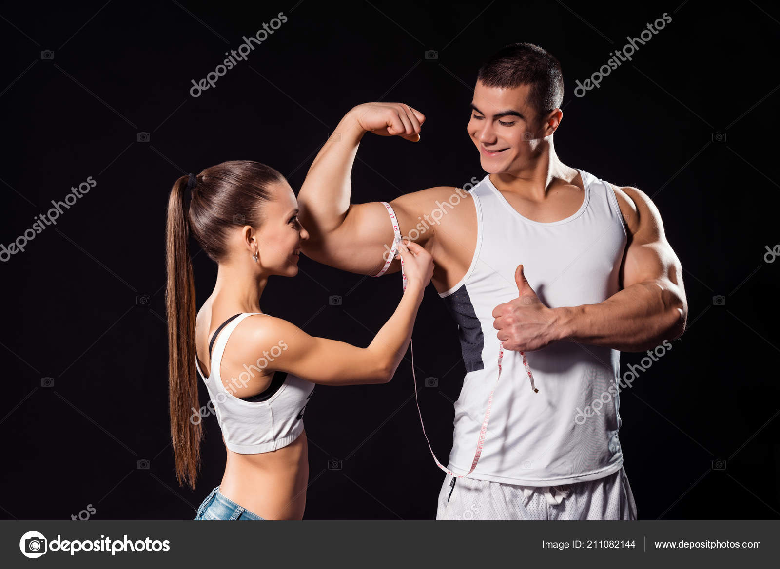 Muscular athlete shows thumb-up. — Stock Photo © YGphoto #211082144