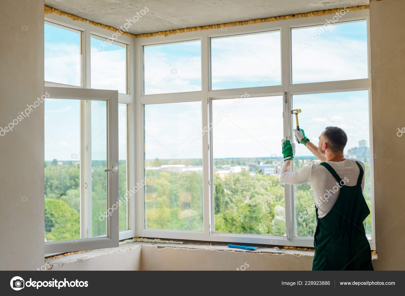 Worker is installing a window Stock Photo by ©YGphoto 228923886