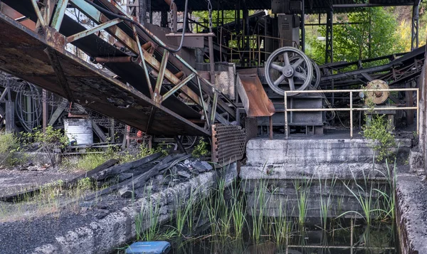 old gears and conveyor from an abandoned coal factory - Stock Image ...