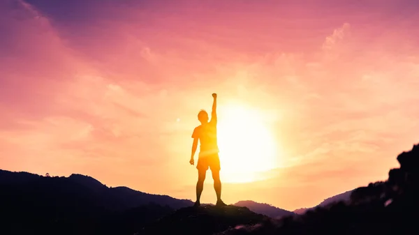 Copy space of man rise hand up on top of mountain and sunset sky ...