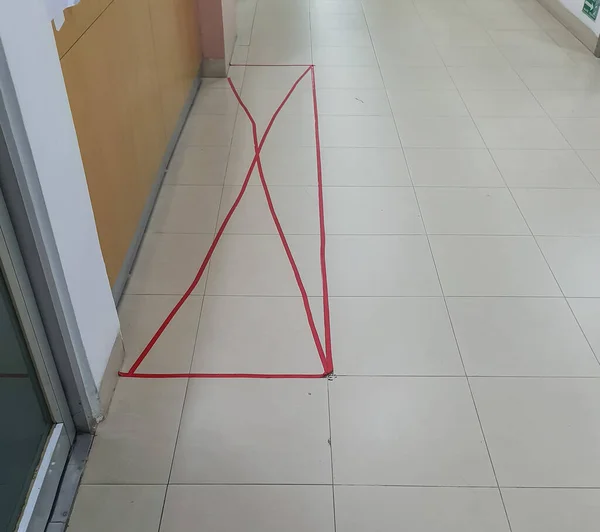 Crossed mark area to keep safe distance from the reception desk due to ...